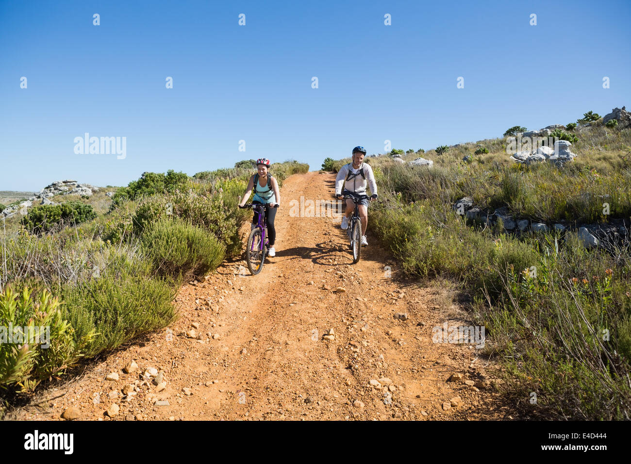Active couple cycling on country terrain together Stock Photo - Alamy