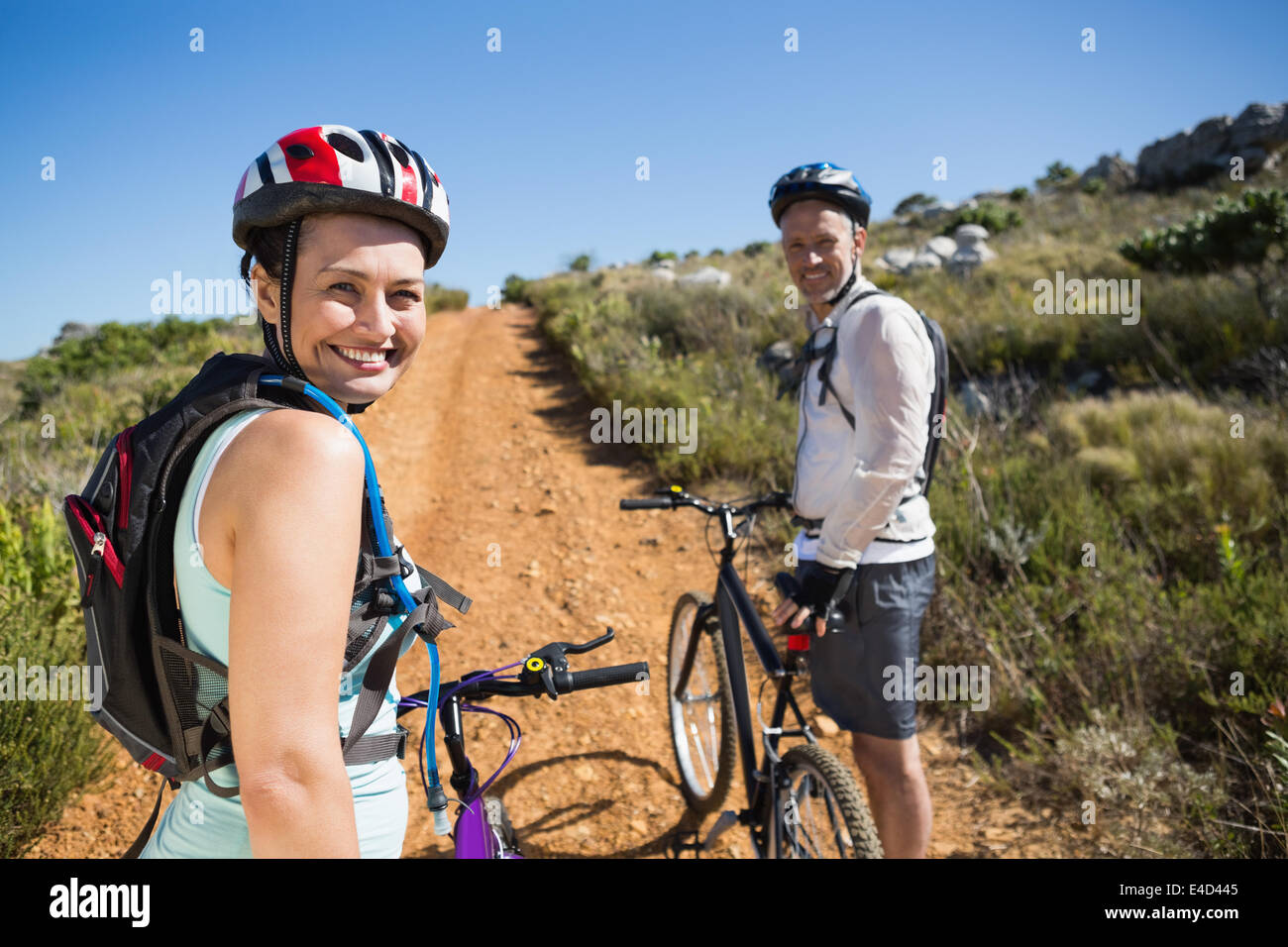 Active couple cycling on country terrain together Stock Photo - Alamy