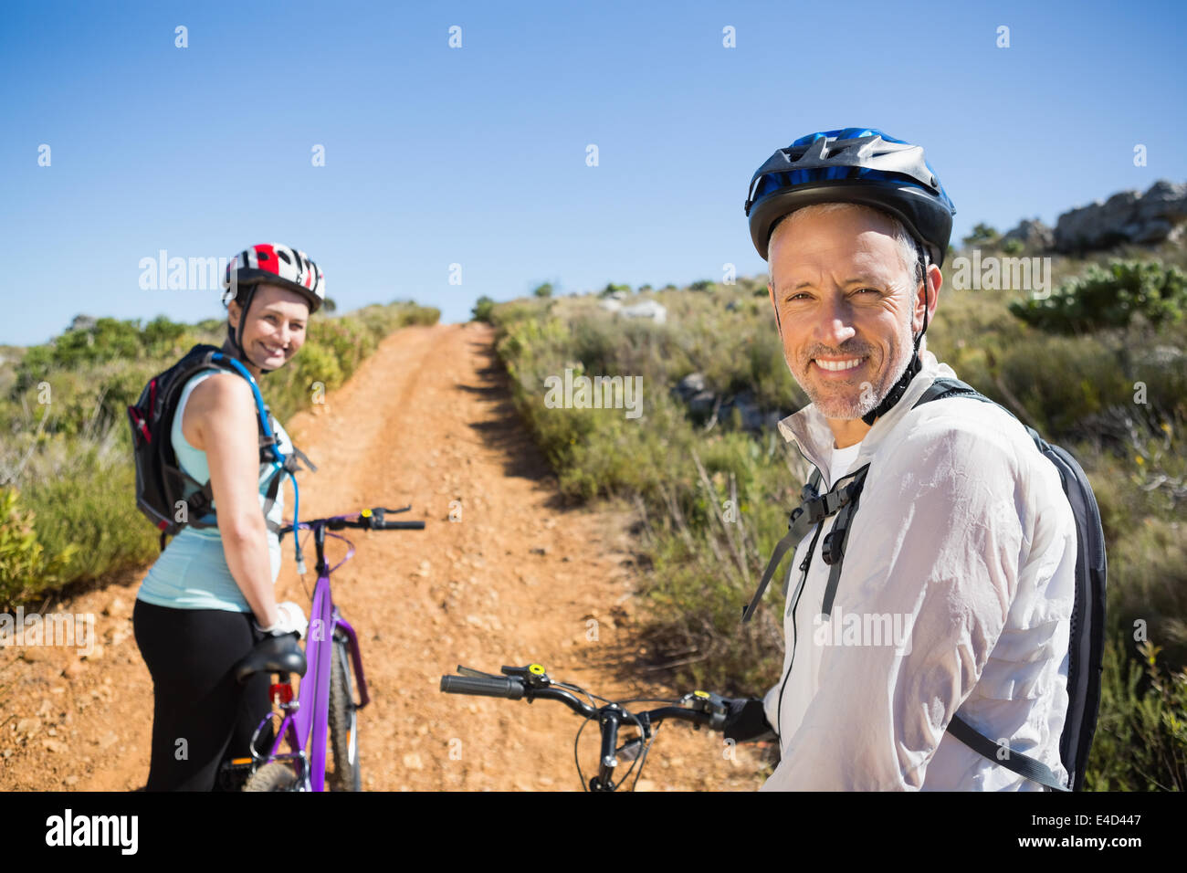 Active couple cycling on country terrain together Stock Photo - Alamy