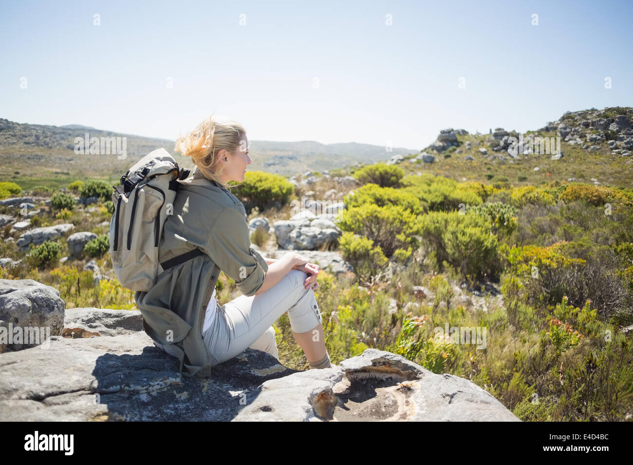 Pretty hiker sitting at the summit Stock Photo - Alamy