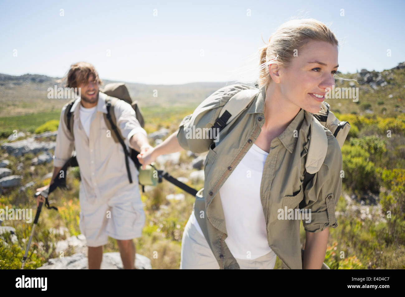 Hiking couple walking on mountain terrain Stock Photo - Alamy