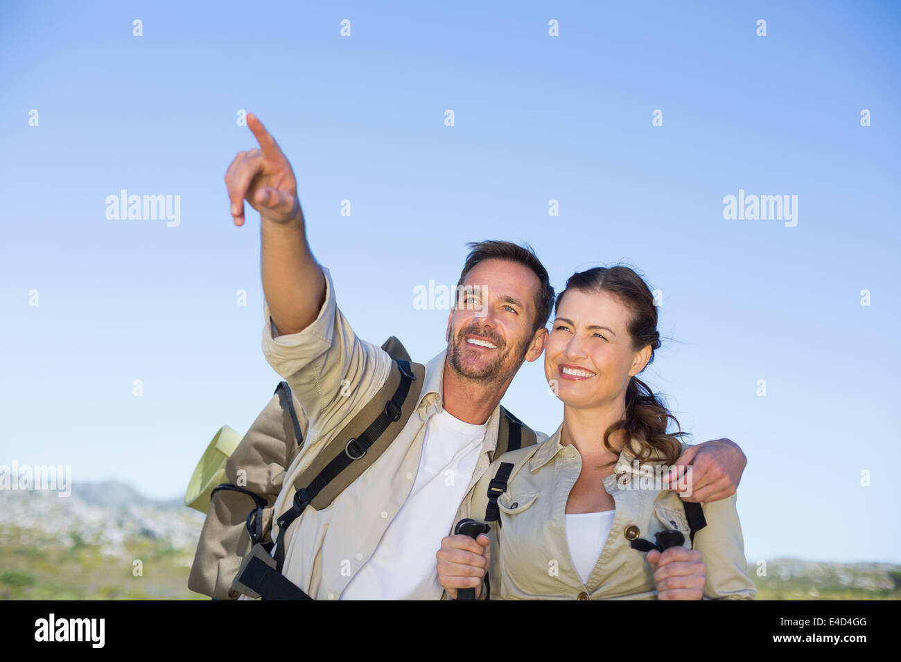 Hiking couple pointing and looking in the countryside Stock Photo - Alamy
