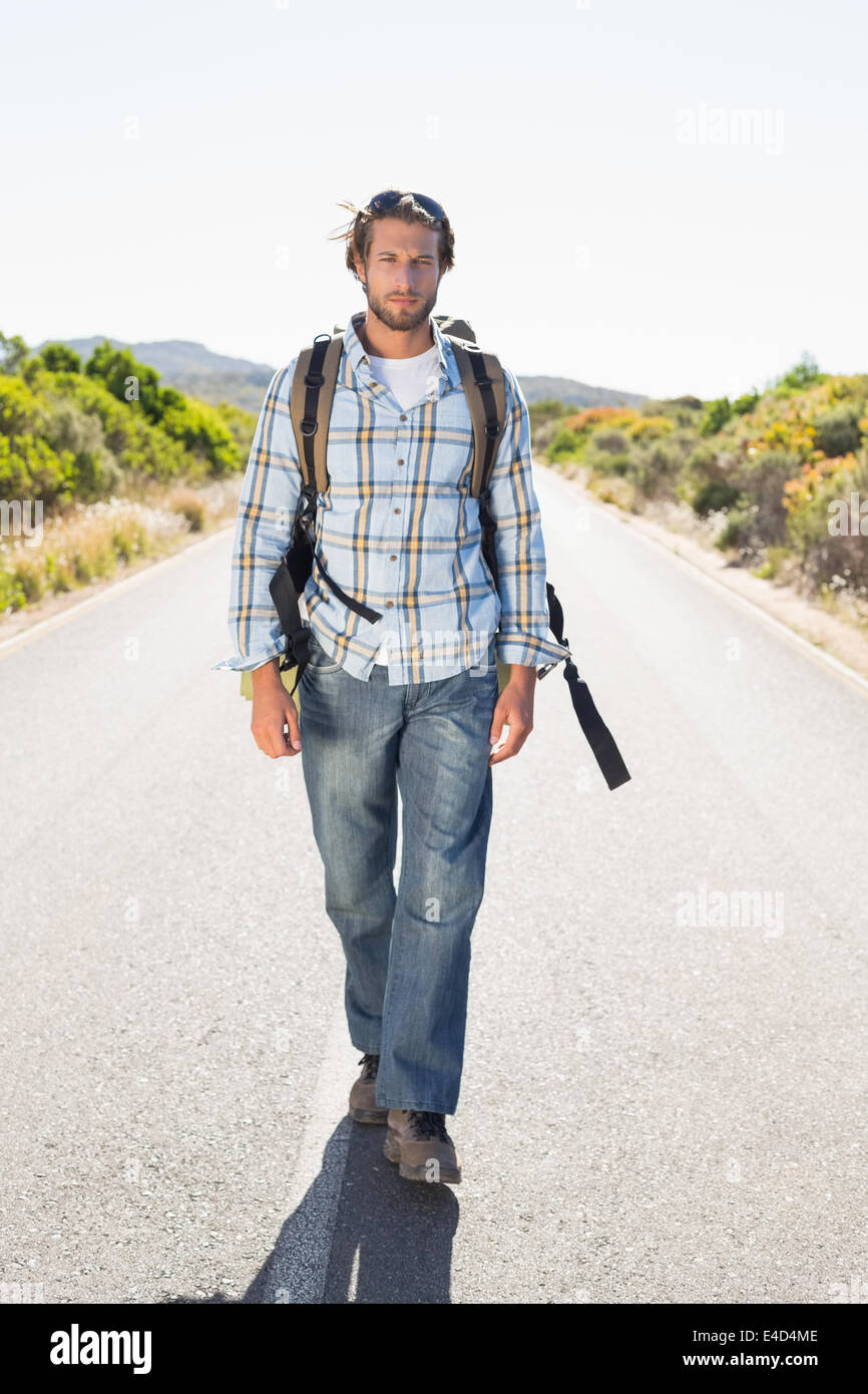 Attractive man walking on rural road Stock Photo - Alamy