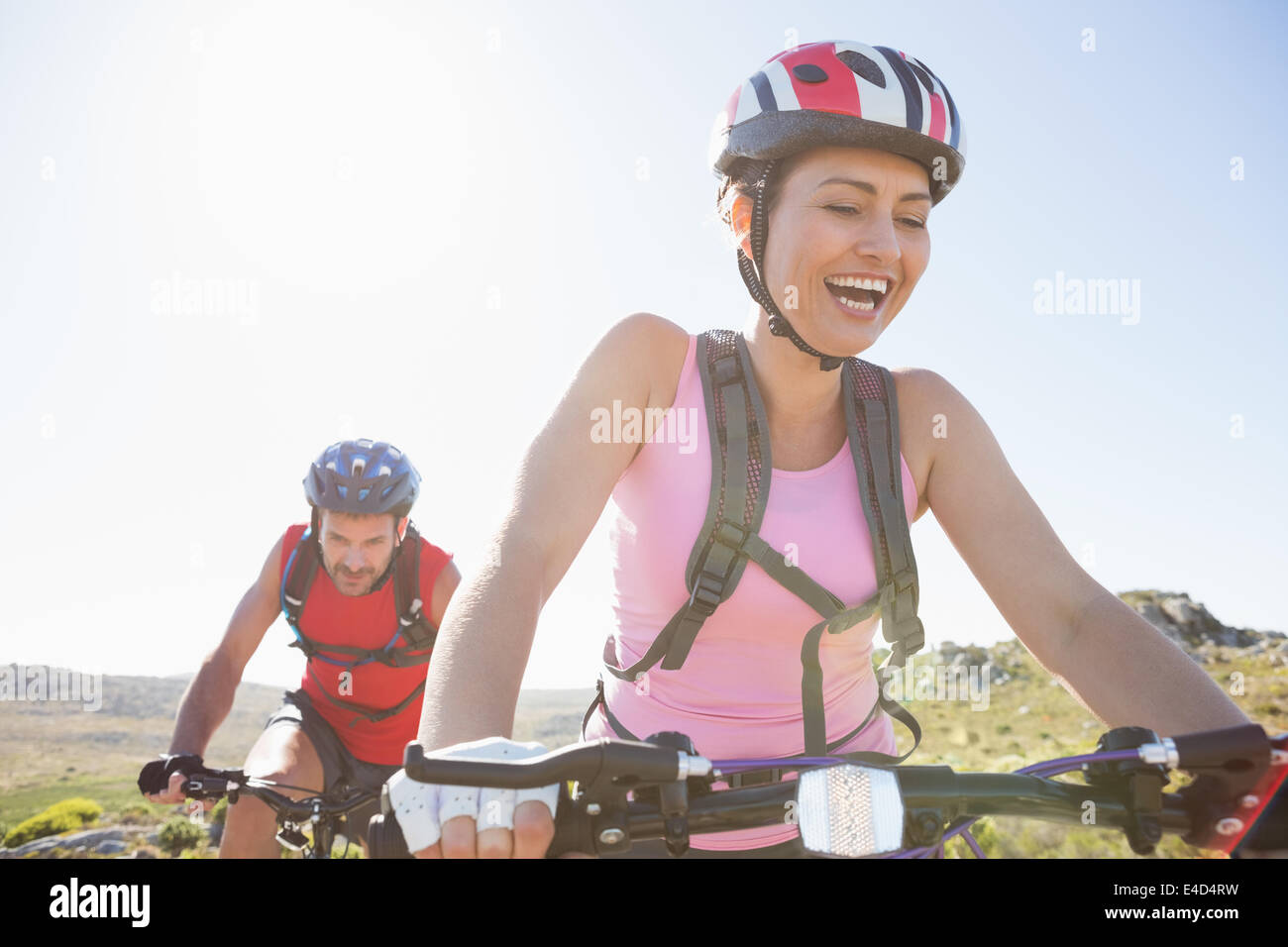 Fit cyclist couple riding together on mountain trail Stock Photo - Alamy