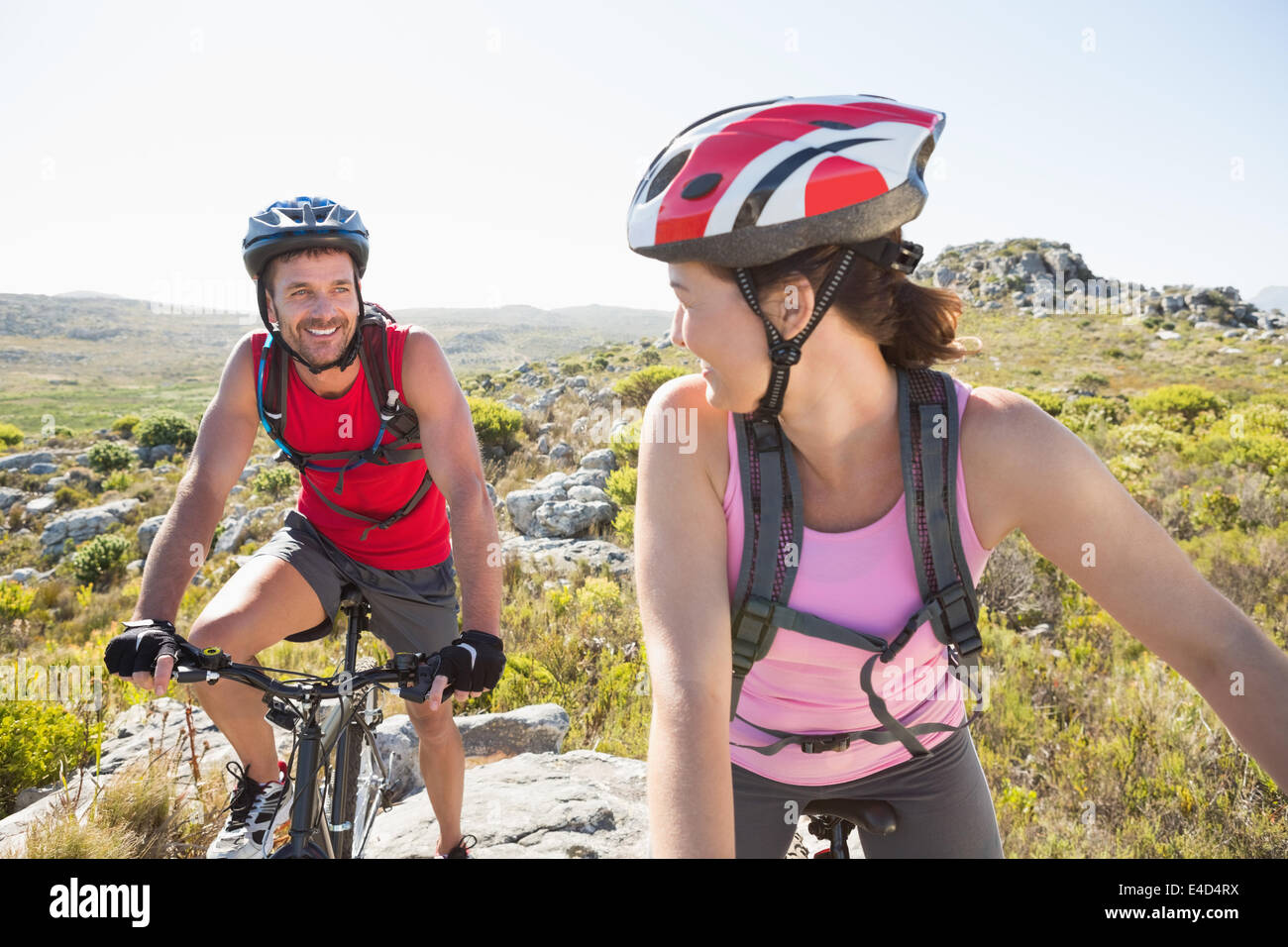 Fit cyclist couple riding together on mountain trail Stock Photo - Alamy