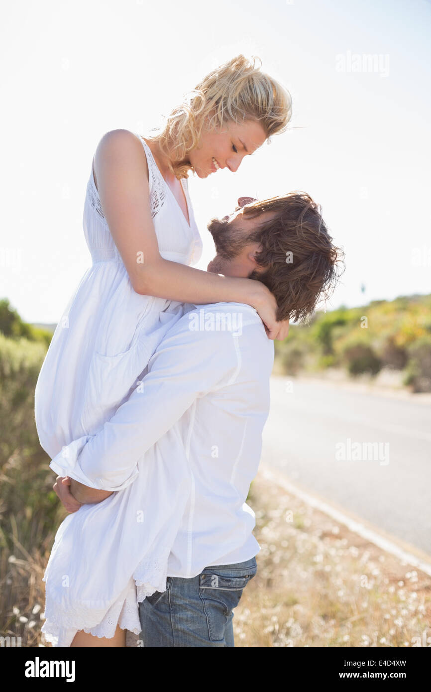 Attractive man lifting up his girlfriend Stock Photo - Alamy