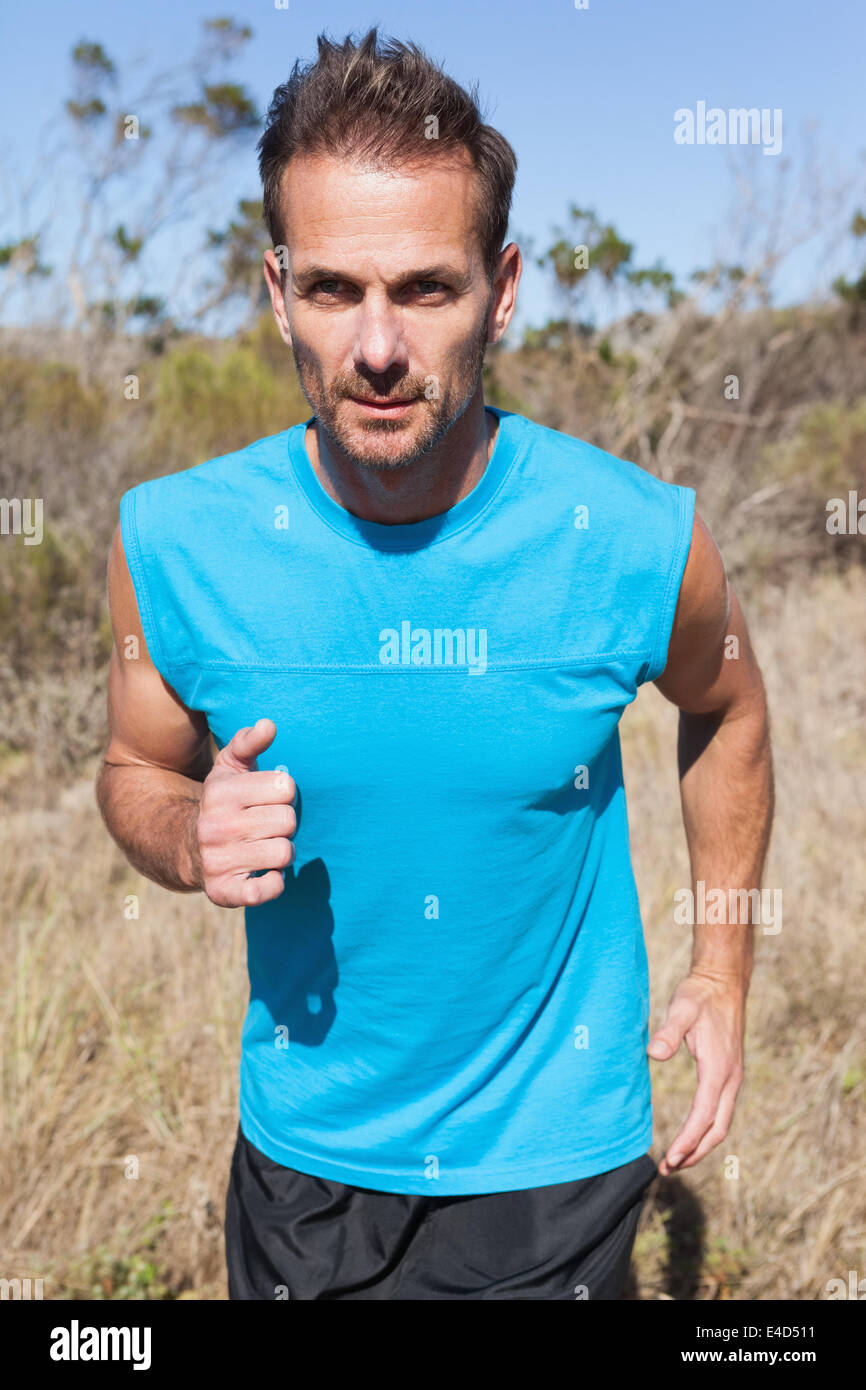 Athletic man jogging in the countryside Stock Photo - Alamy