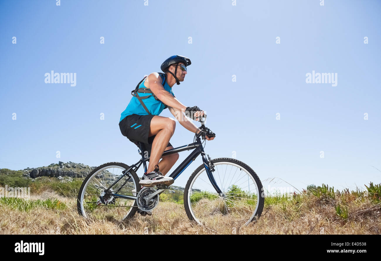 Fit cyclist riding in the countryside Stock Photo - Alamy