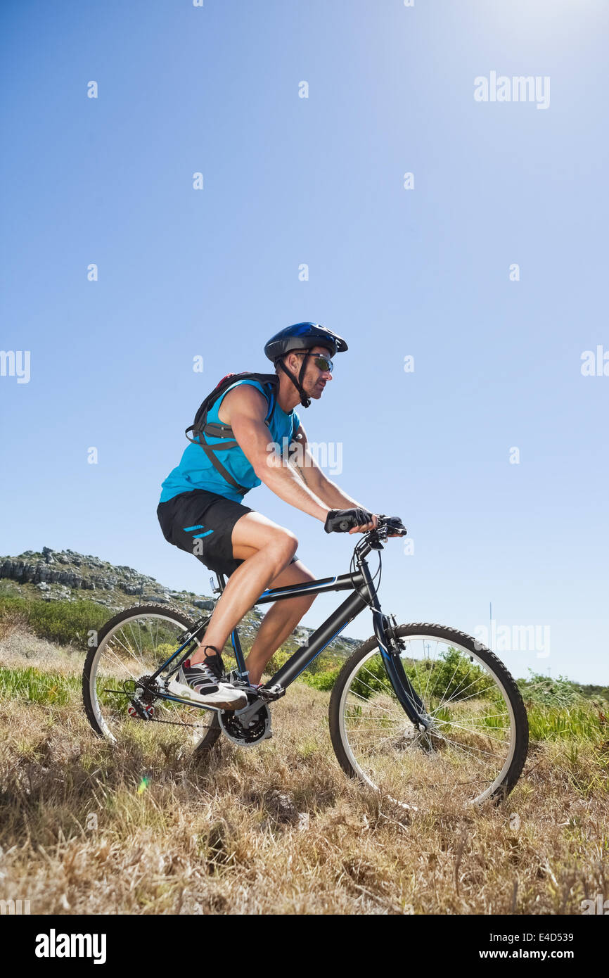 Fit cyclist riding in the countryside Stock Photo - Alamy