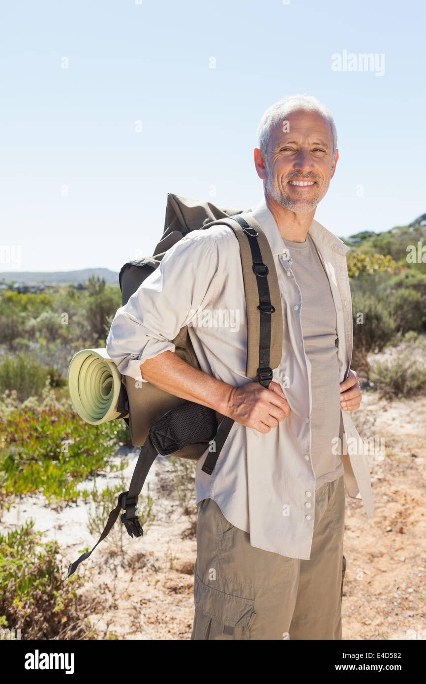 Handsome hiker smiling at camera in the countryside Stock Photo - Alamy
