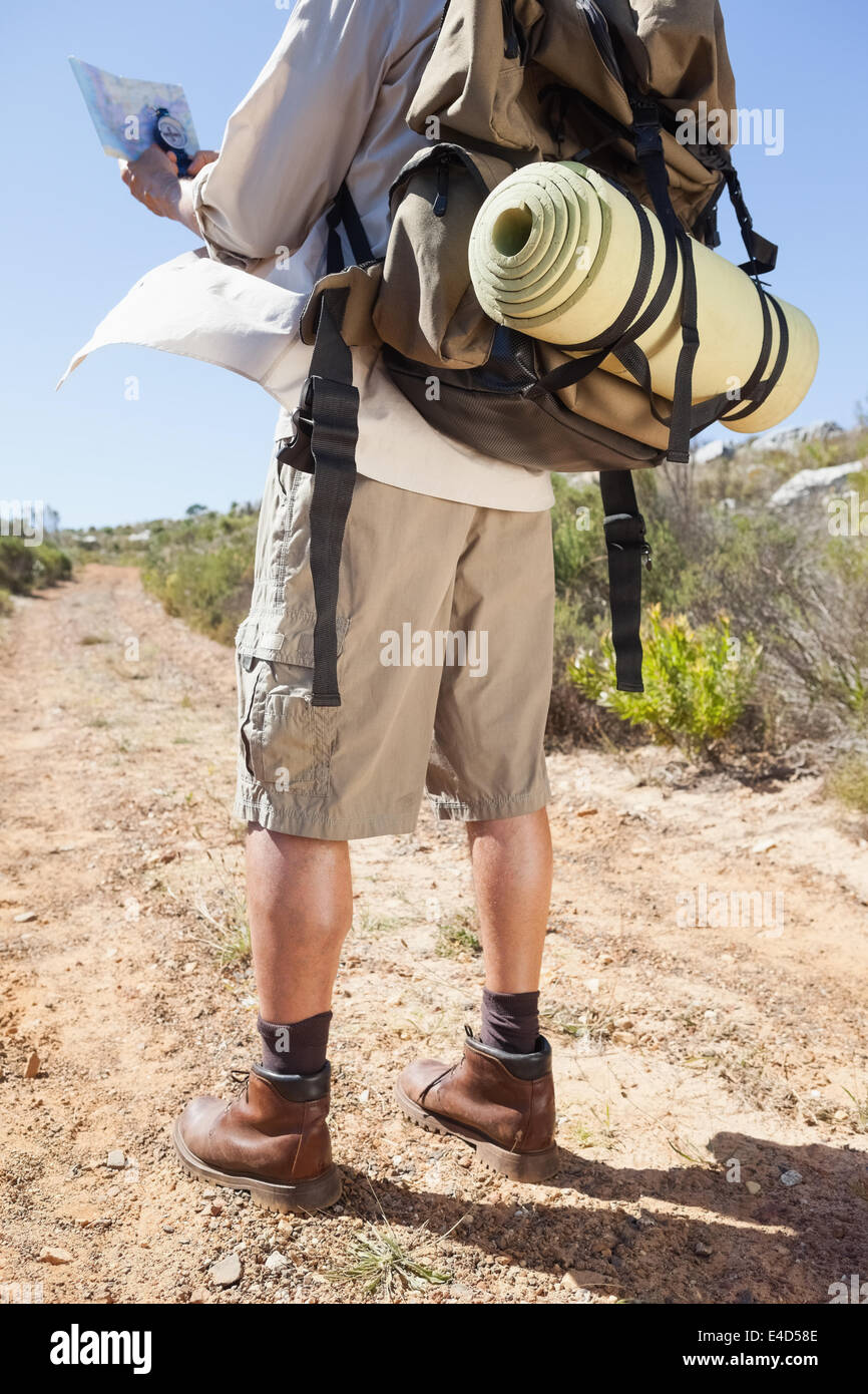 Handsome hiker consulting the map in the countryside Stock Photo - Alamy