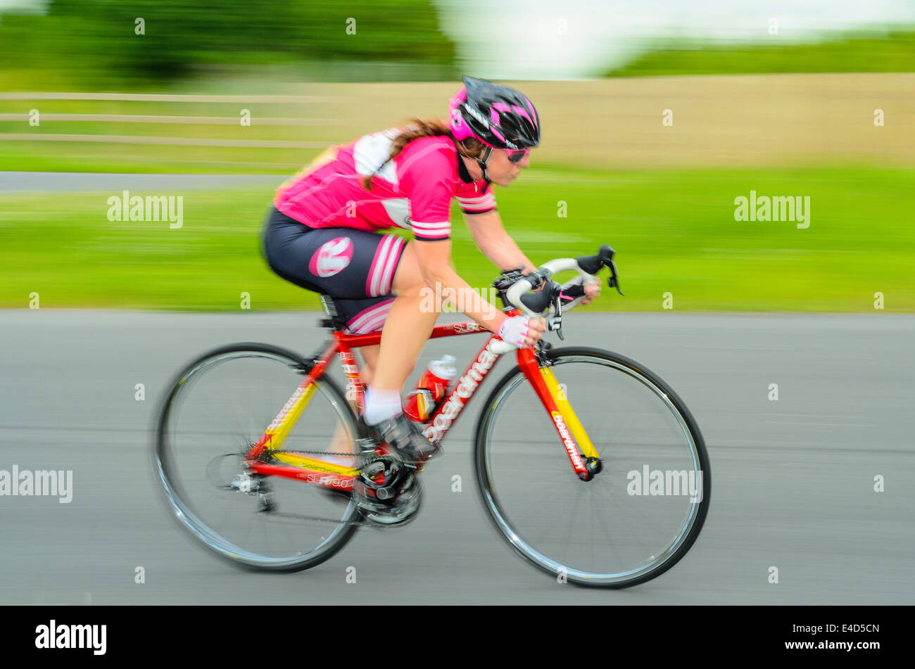 Cyclist racing in women’s criterium event on dedicated cycle circuit at ...