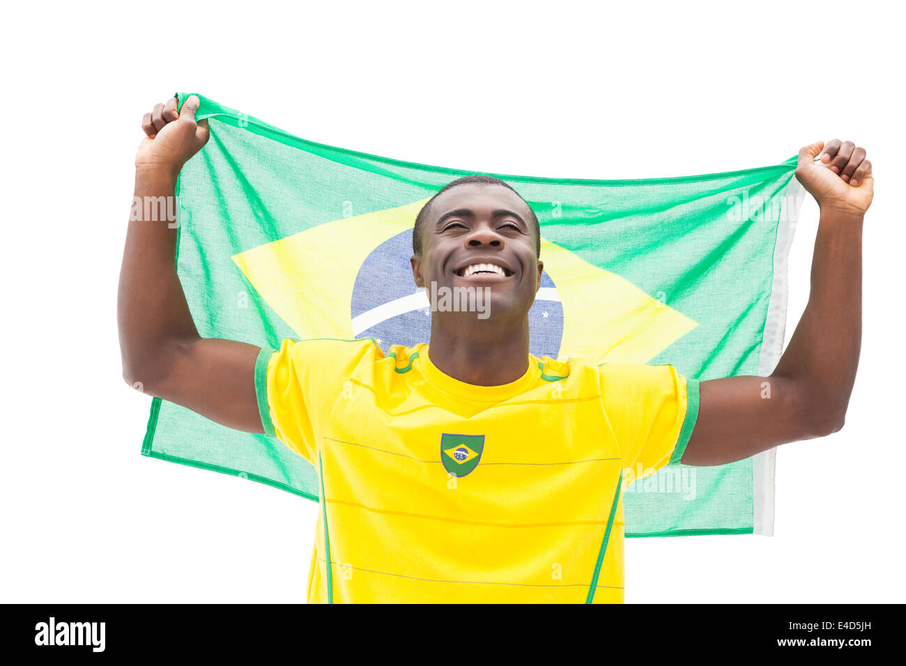 Happy brazilian football fan cheering holding flag Stock Photo - Alamy