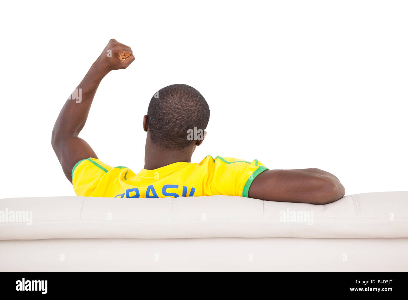 Man sitting on sofa and cheering Stock Photo - Alamy