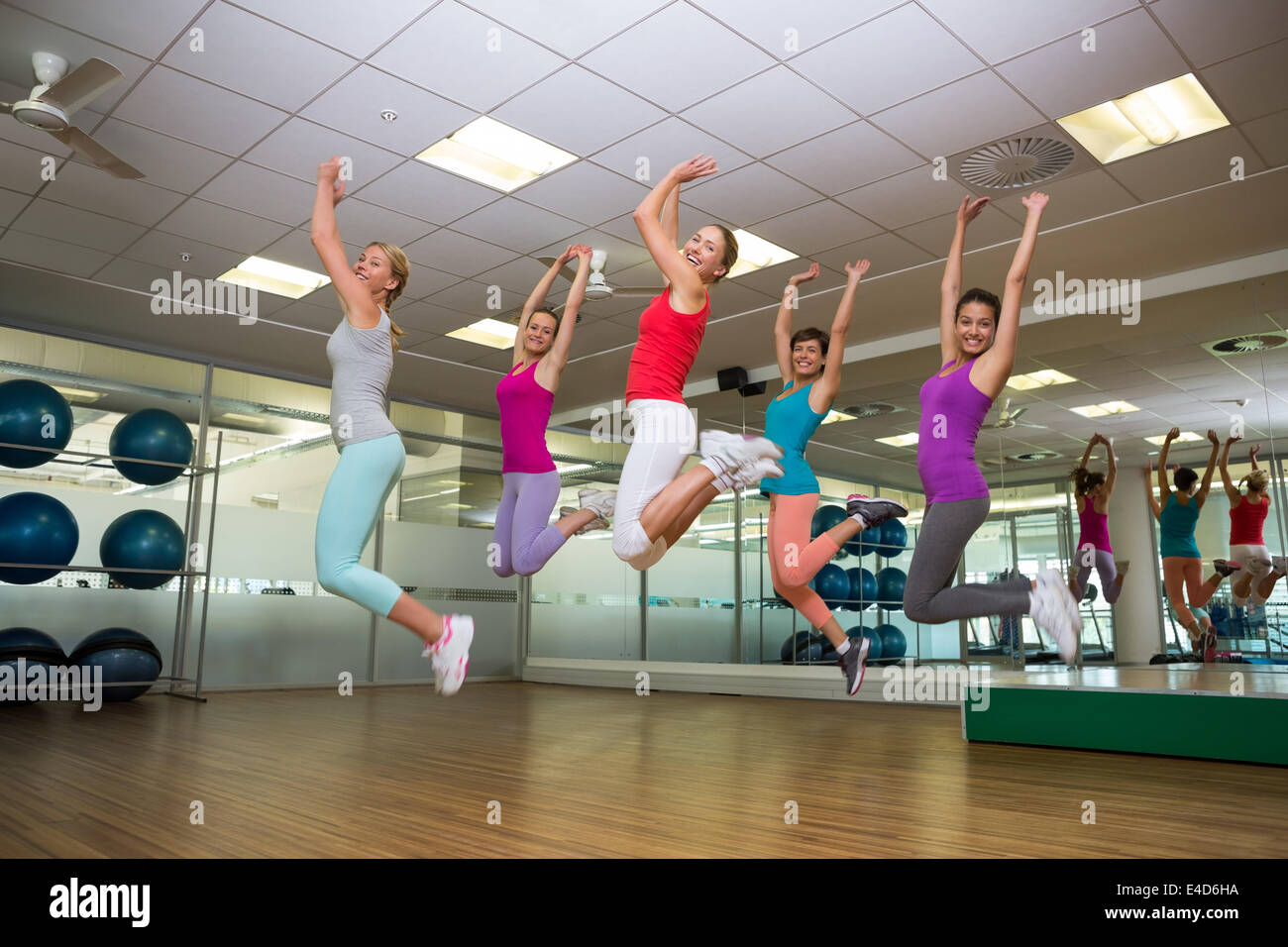 Fitness class jumping up in studio Stock Photo - Alamy