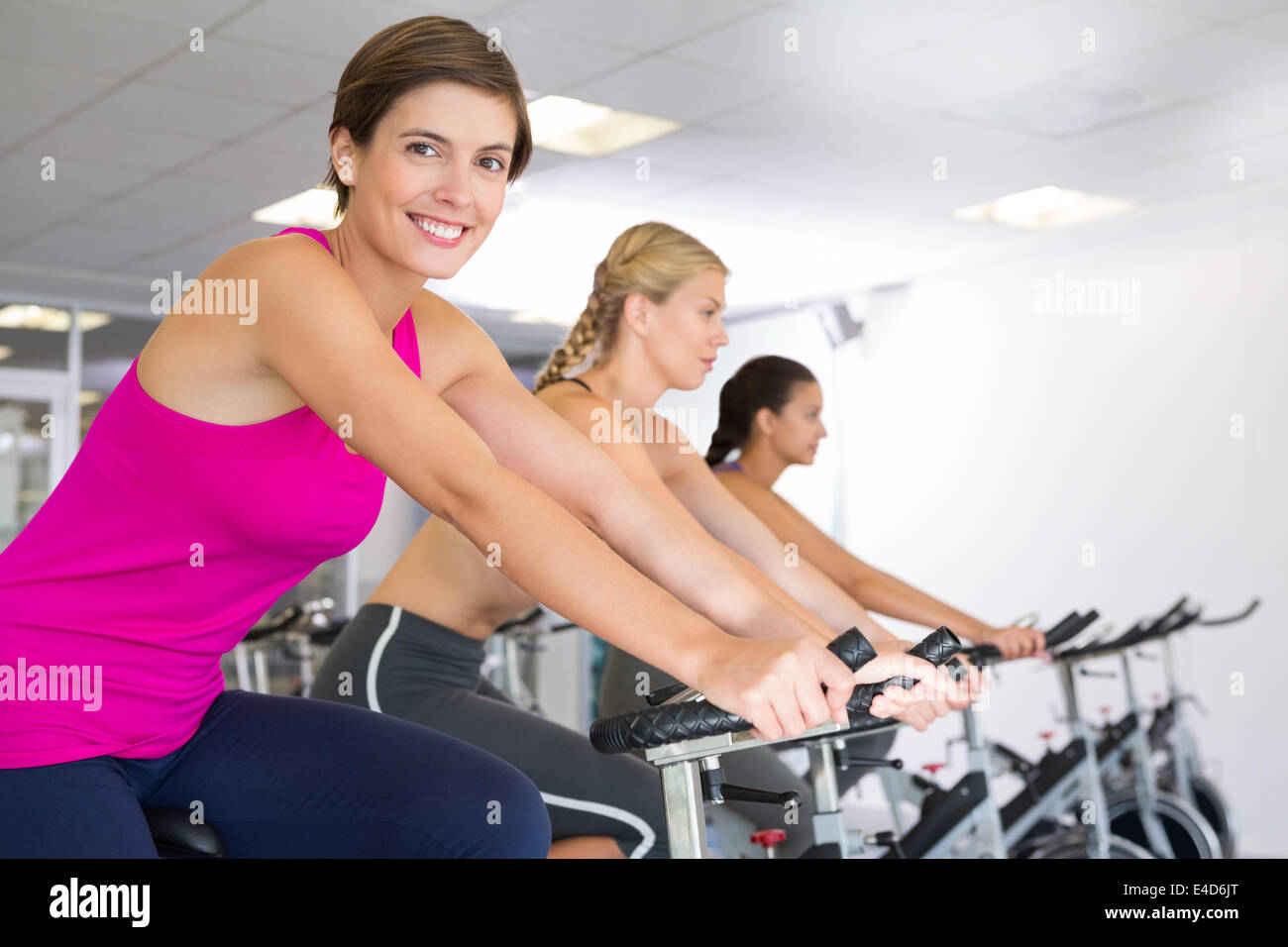 Spin class working out in a row Stock Photo - Alamy