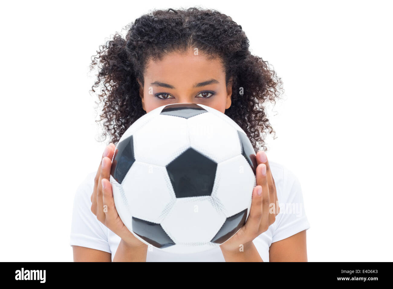 Pretty football fan in white holding ball over face Stock Photo - Alamy