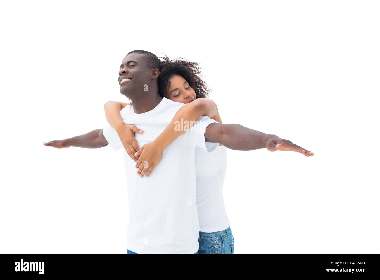 Casual couple standing with arms outstretched Stock Photo - Alamy