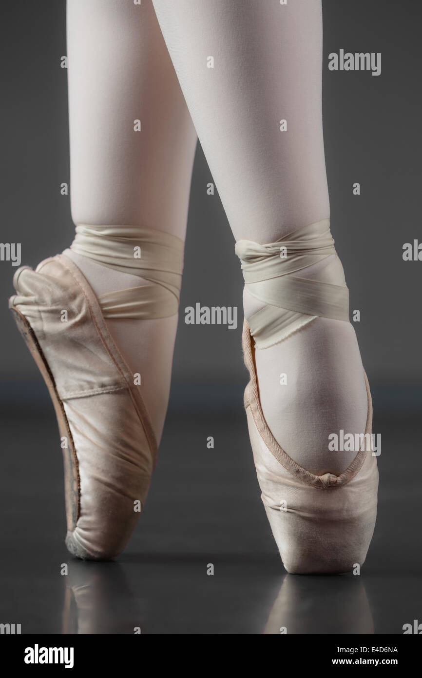 Ballerina standing en pointe in ballet slippers Stock Photo - Alamy