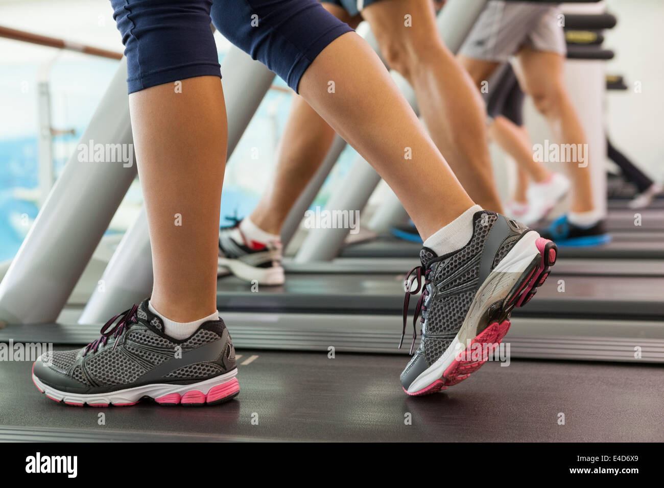 Row of people working out on treadmills Stock Photo - Alamy