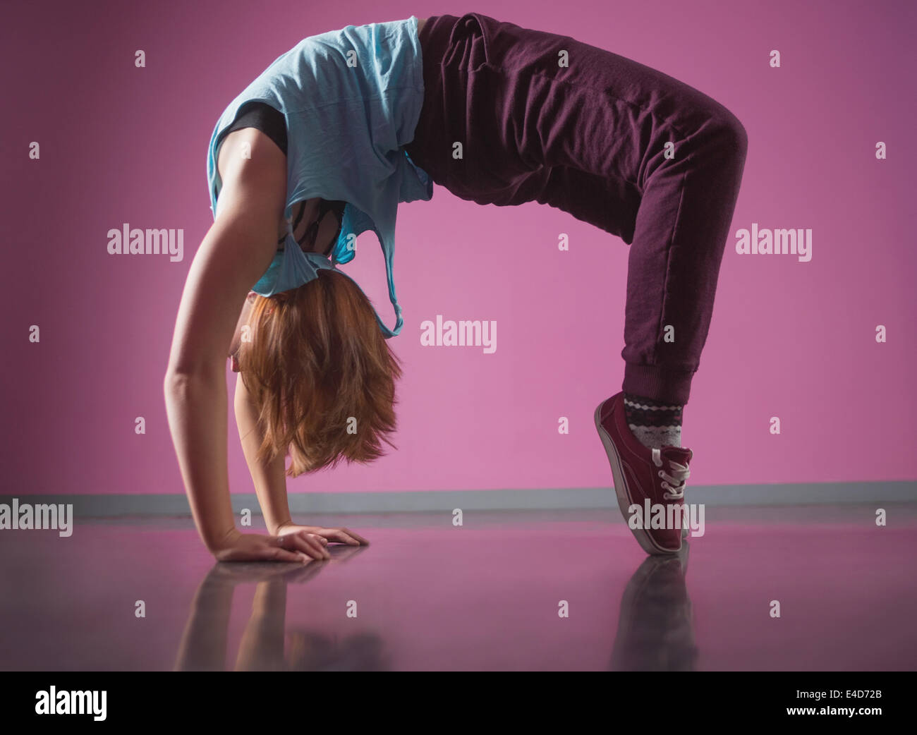 Pretty break dancer doing a back bend Stock Photo - Alamy