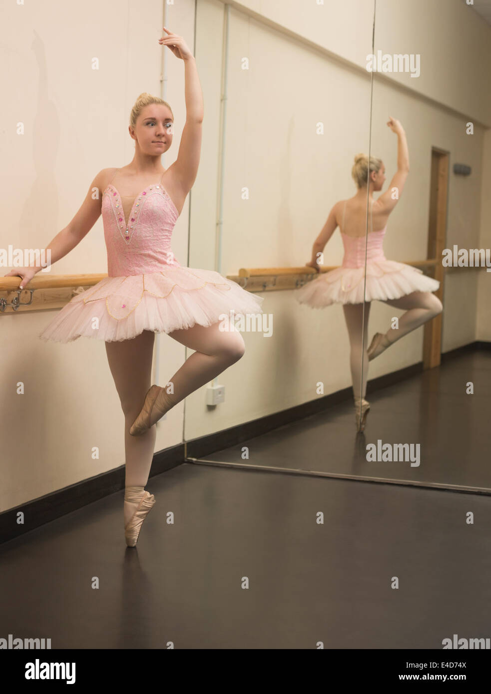 Beautiful ballerina standing en pointe with the barre Stock Photo - Alamy