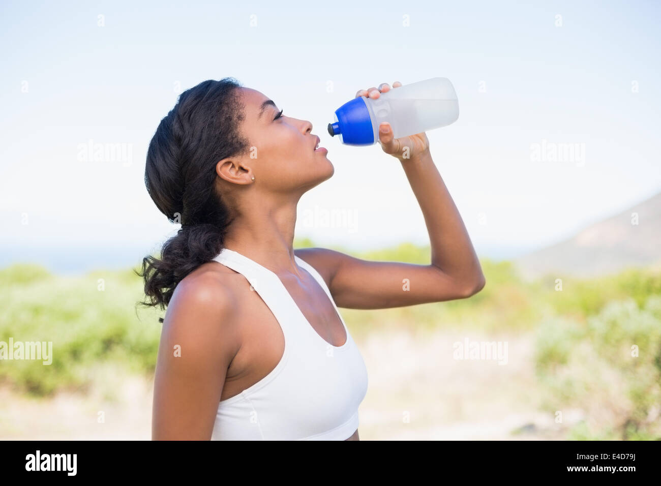 Fit woman drinking water from sports bottle Stock Photo - Alamy