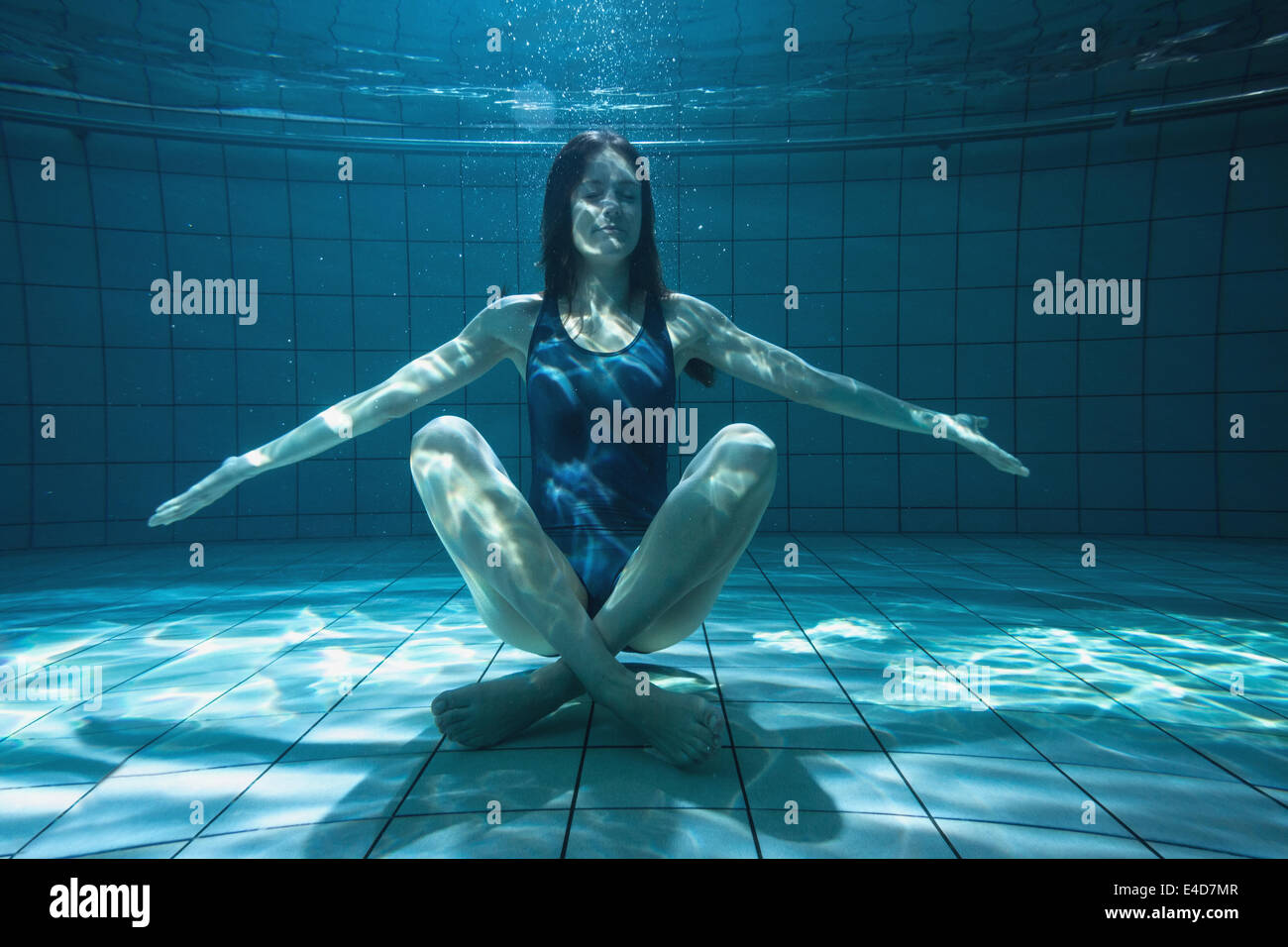 Athletic swimmer smiling at camera underwater Stock Photo - Alamy
