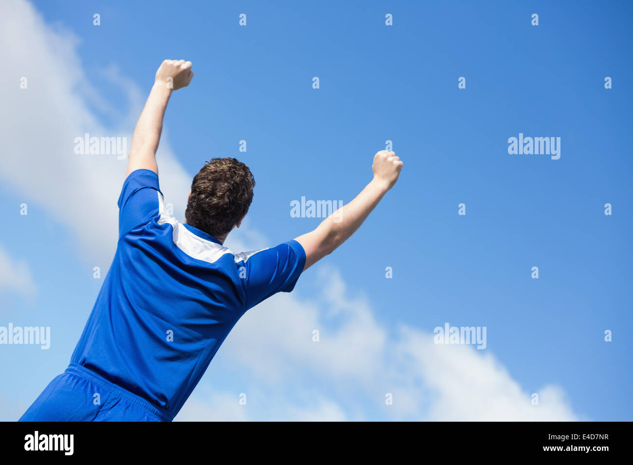 Football player in blue cheering Stock Photo - Alamy