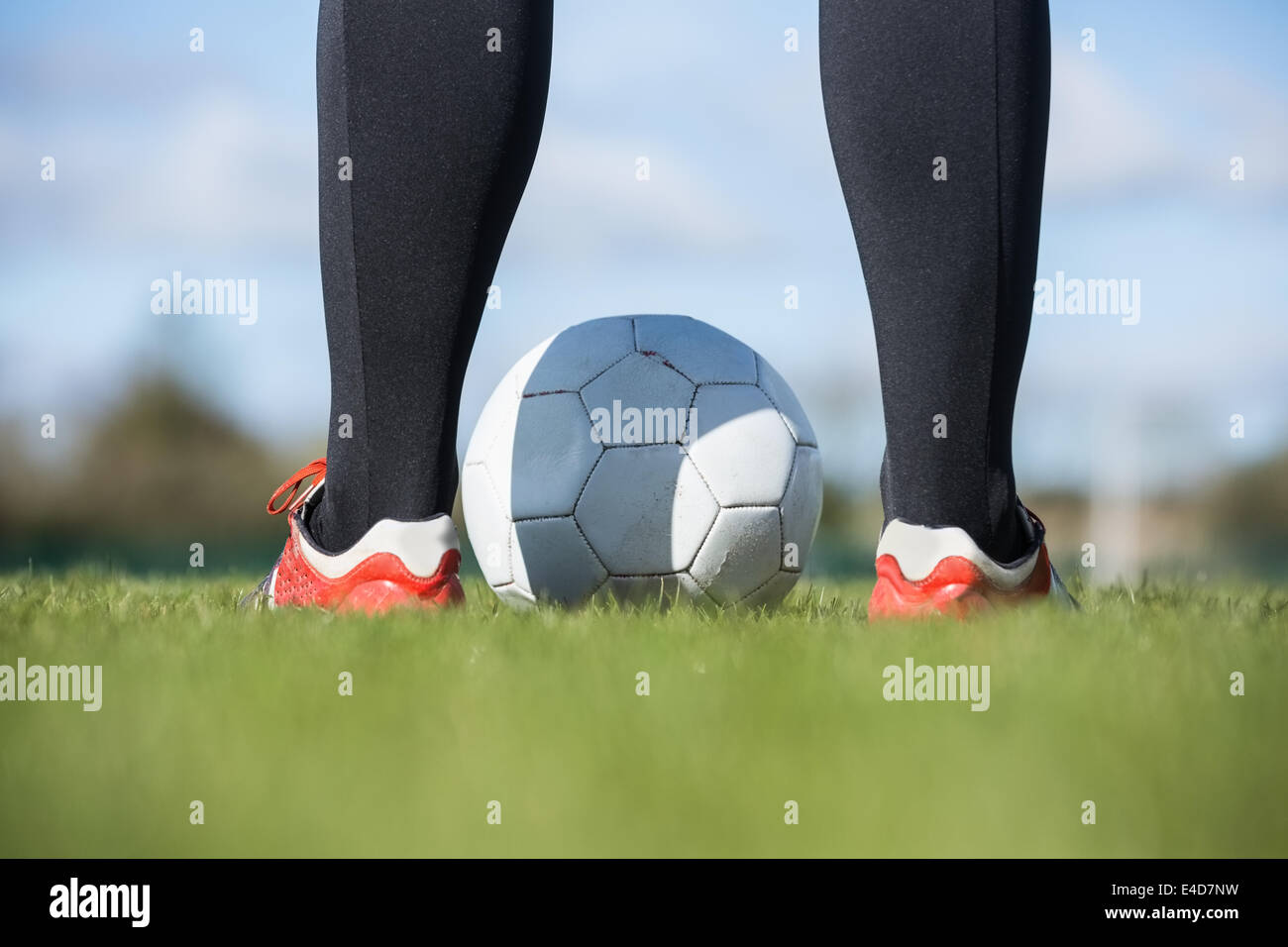 Football player standing with the ball Stock Photo - Alamy