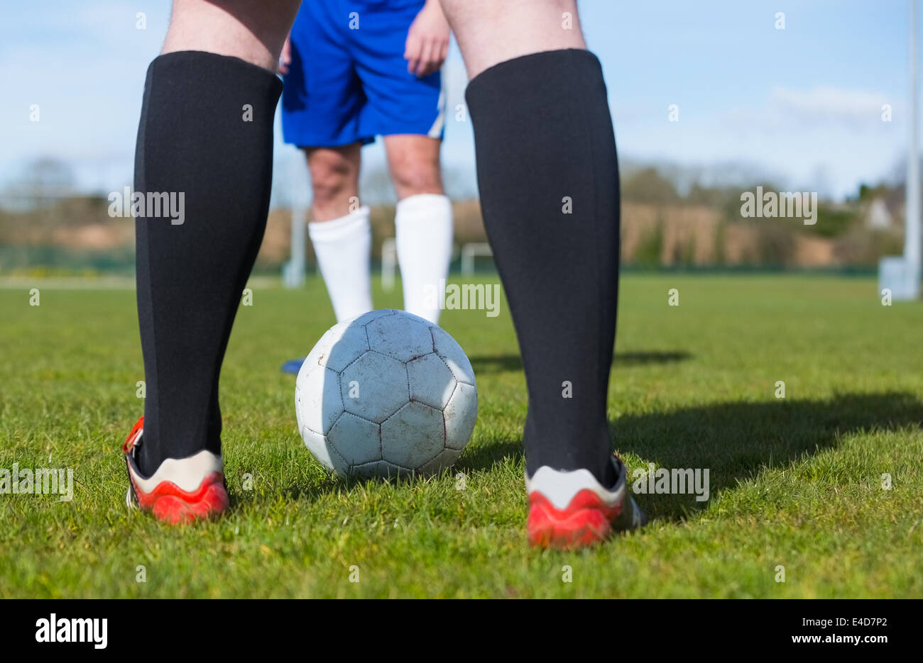 Football players facing off on pitch Stock Photo - Alamy