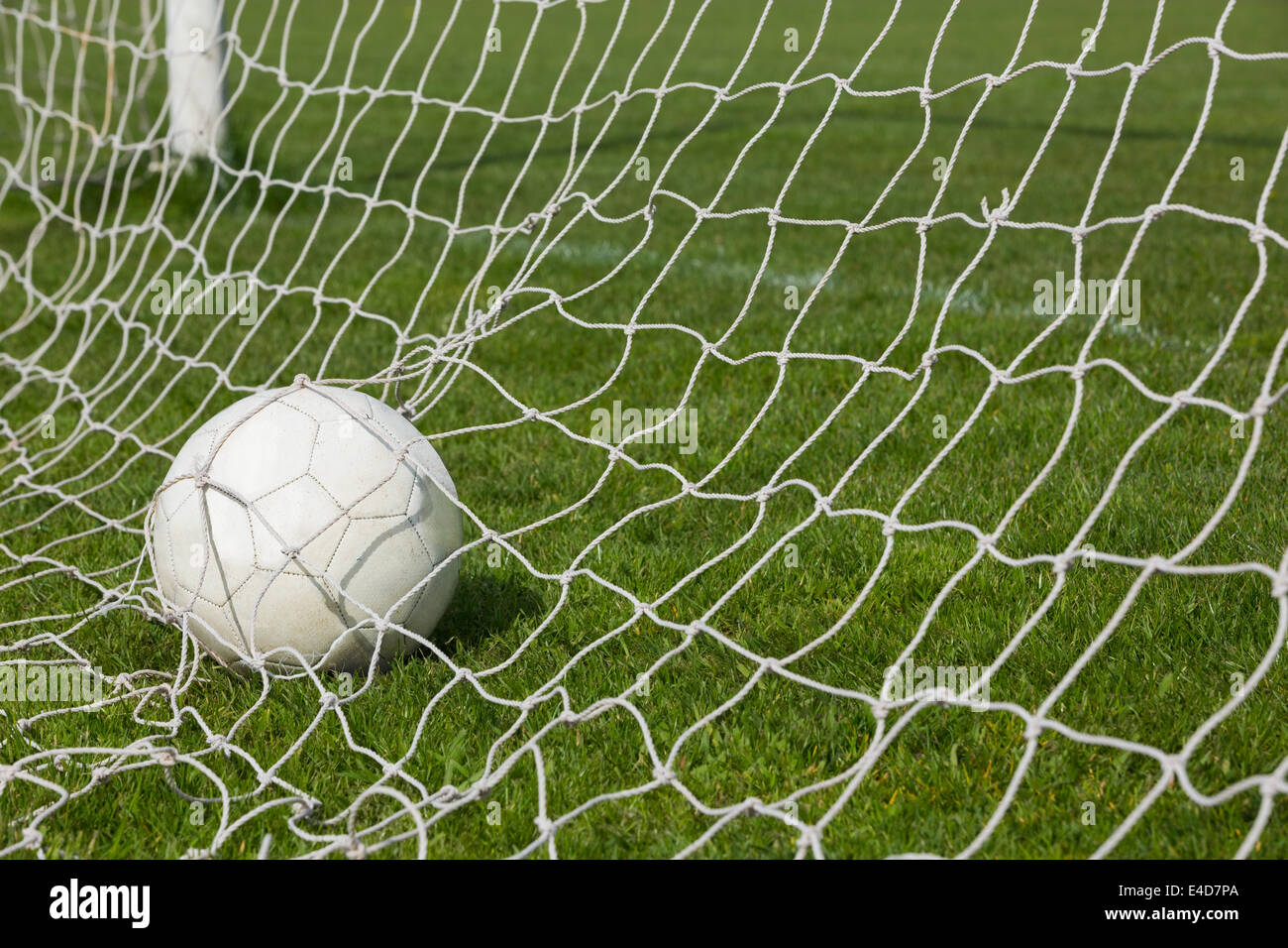 Football at the back of the net Stock Photo - Alamy