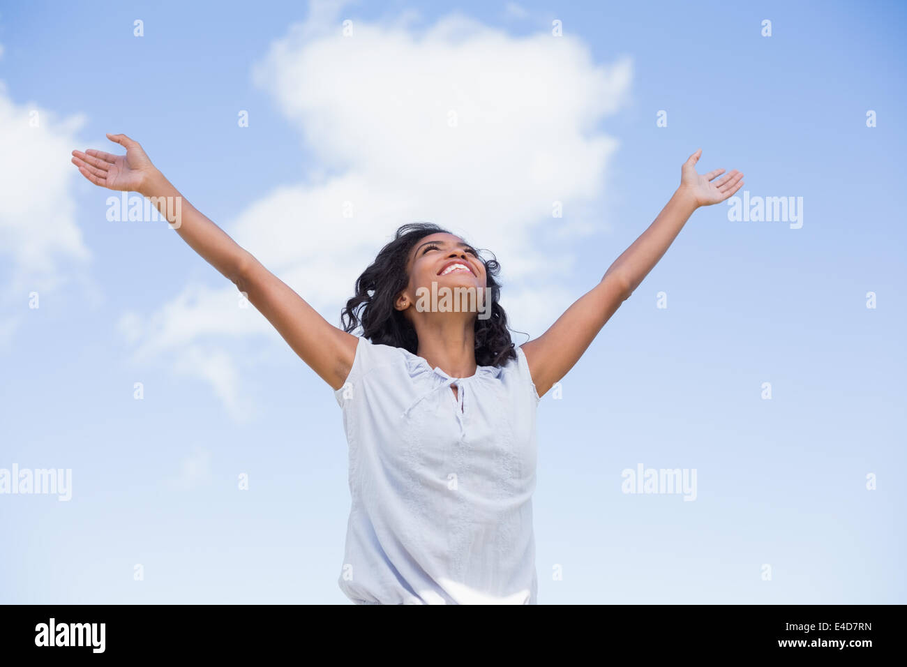 Casual pretty woman standing with arms up Stock Photo - Alamy