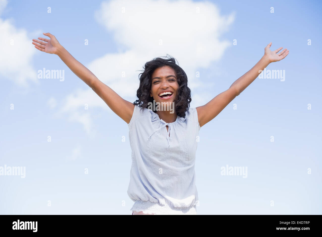 Casual pretty woman standing with arms up Stock Photo - Alamy