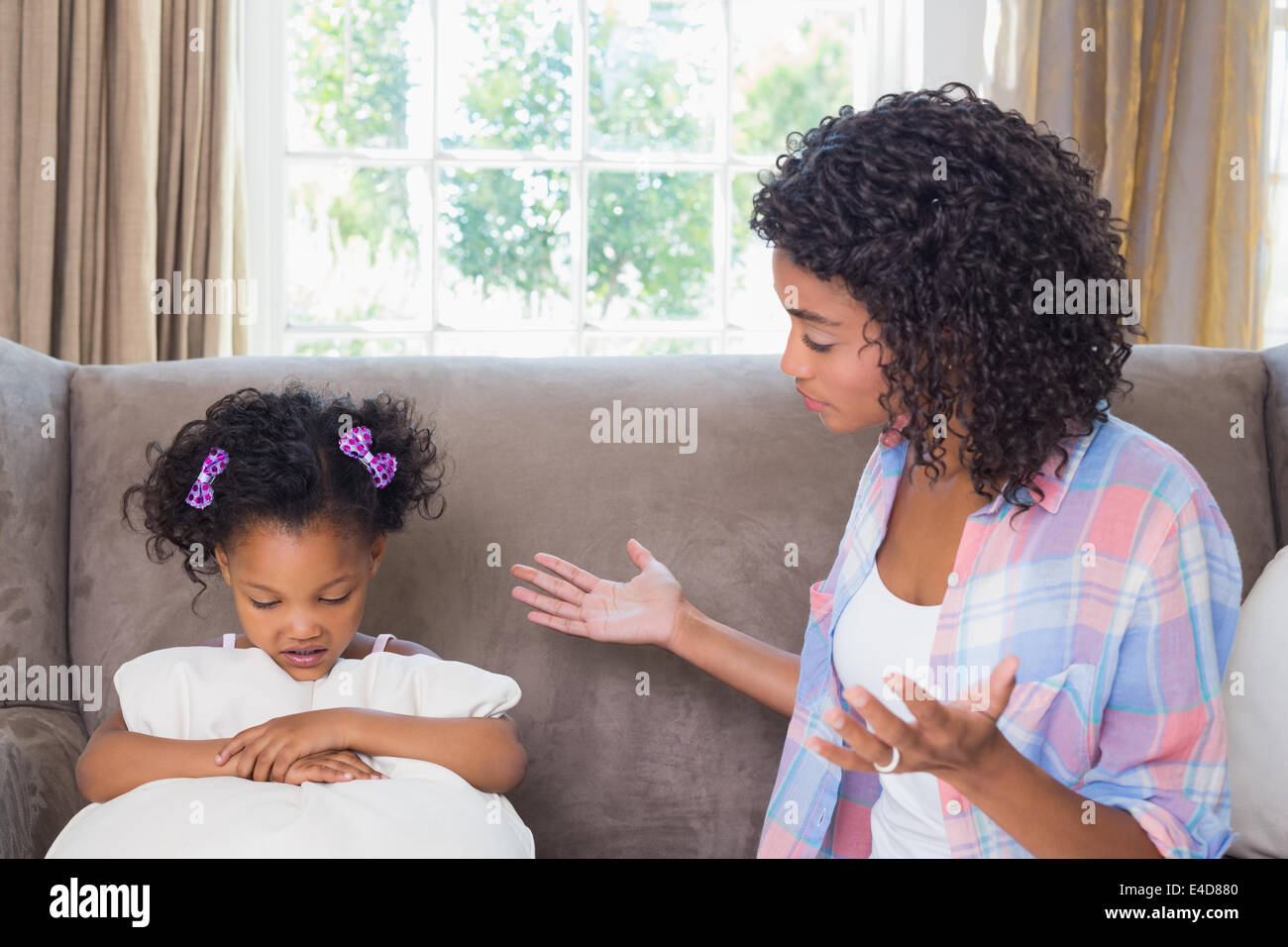 Pretty mother scolding her daughter on the couch Stock Photo - Alamy