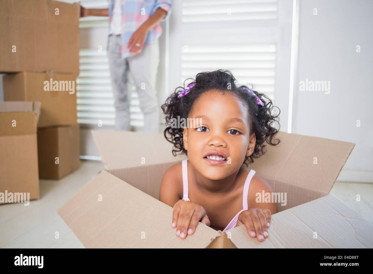 Cute daughter sitting in moving box Stock Photo - Alamy