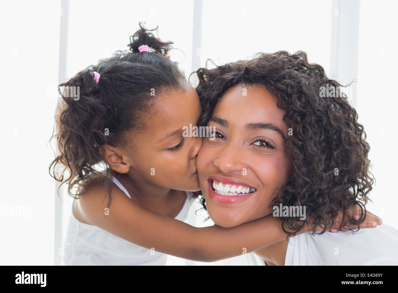 Portrait mother kissing cute daughter hi-res stock photography and ...
