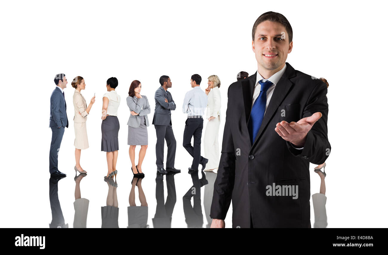Composite image of handsome businessman holding hand out Stock Photo ...