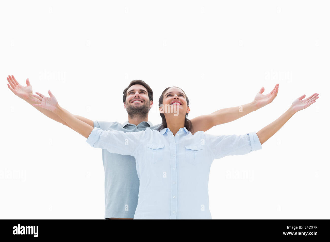Cute couple standing with arms out Stock Photo - Alamy