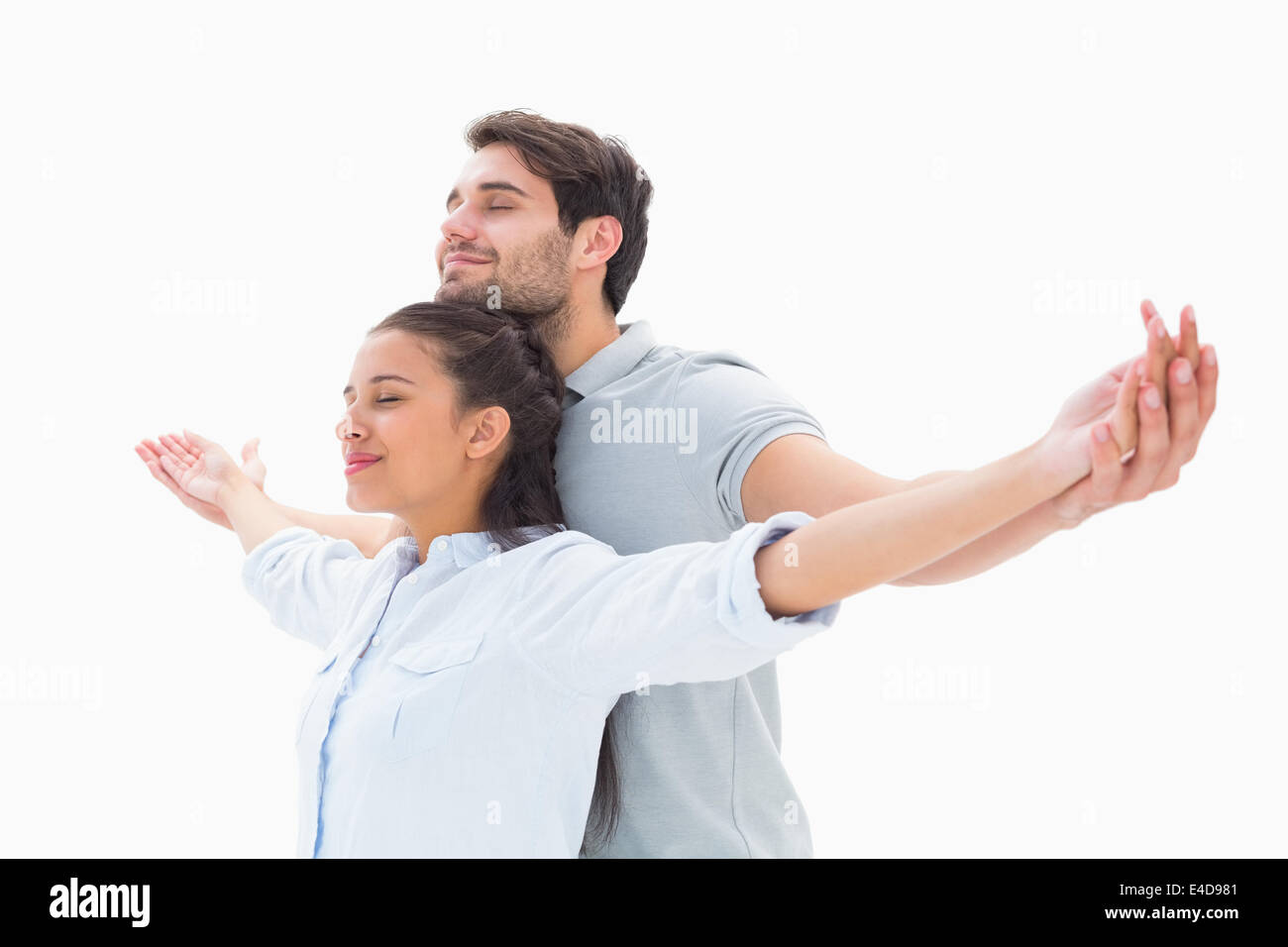 Cute couple standing with arms out Stock Photo - Alamy