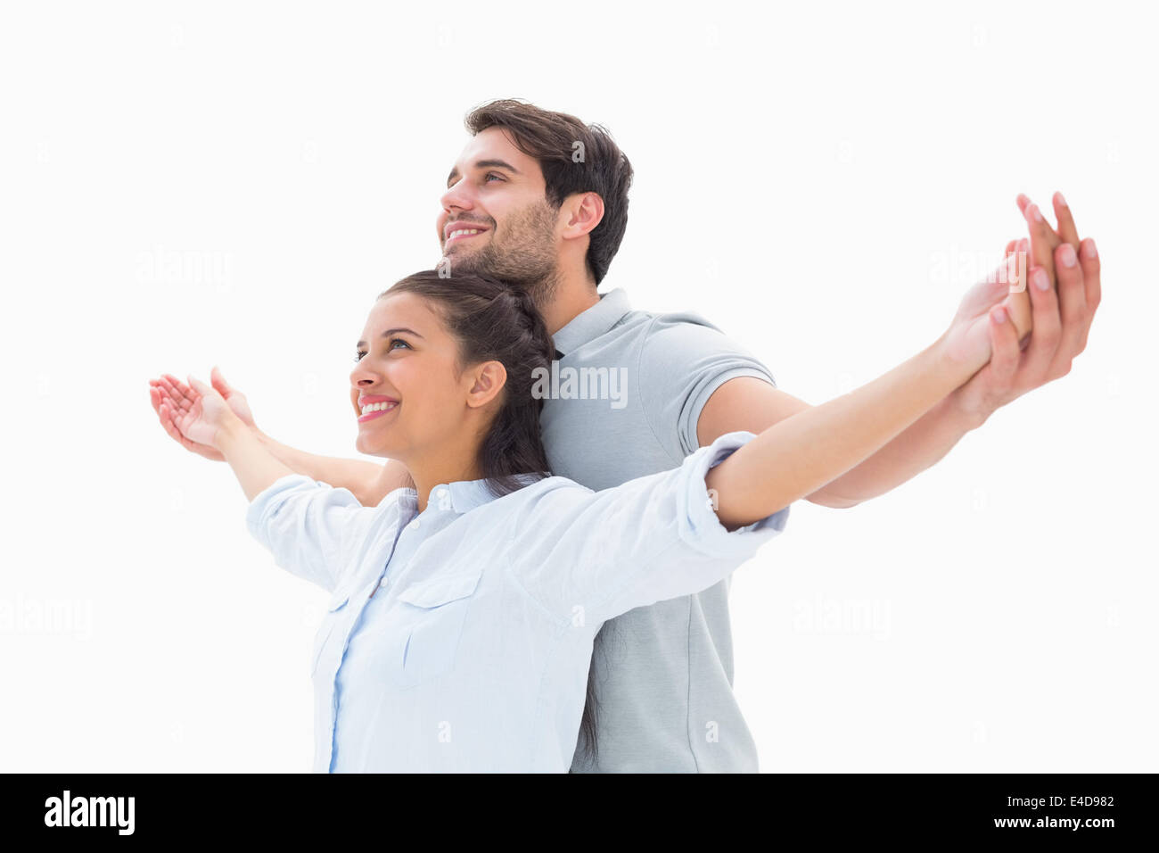 Cute couple standing with arms out Stock Photo - Alamy