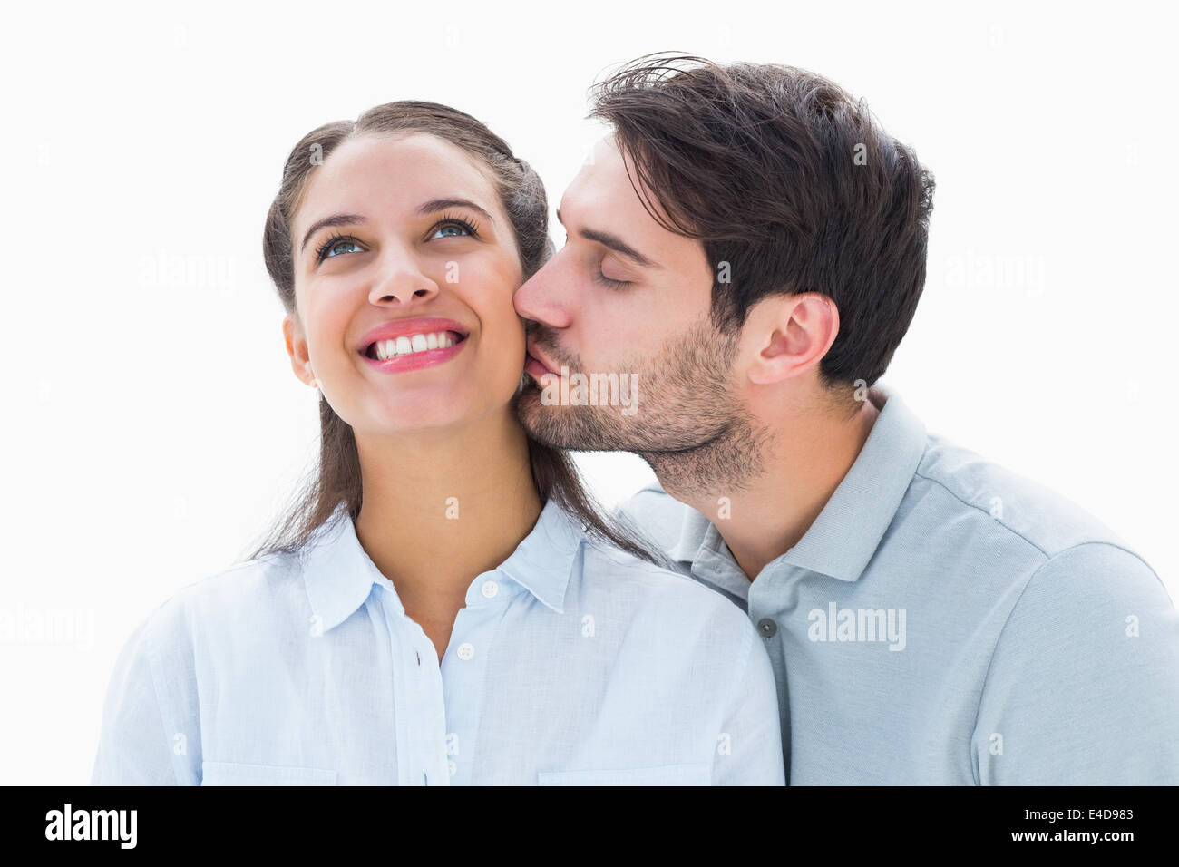 Handsome man kissing girlfriend on cheek Stock Photo - Alamy