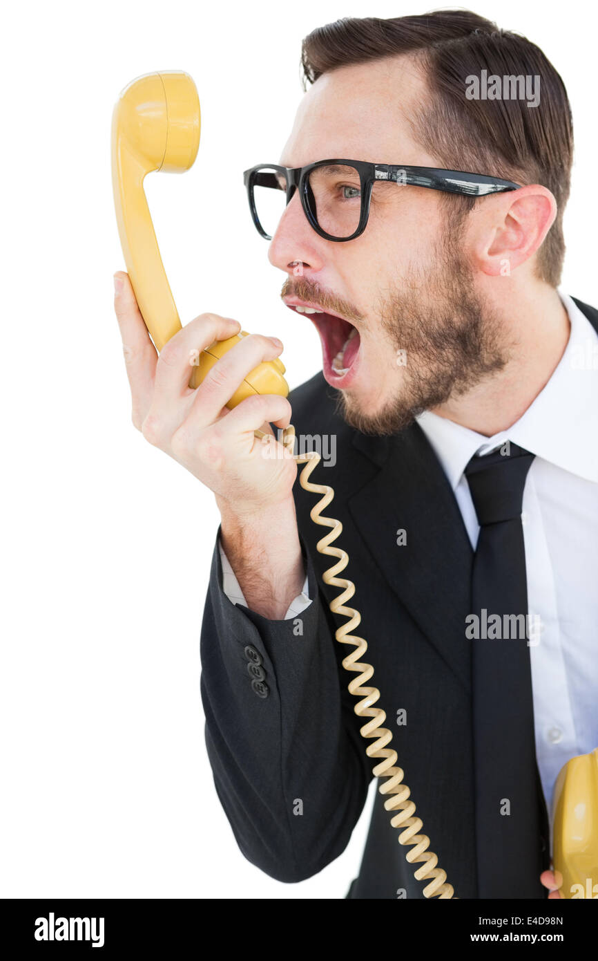 Geeky businessman shouting at telephone Stock Photo - Alamy
