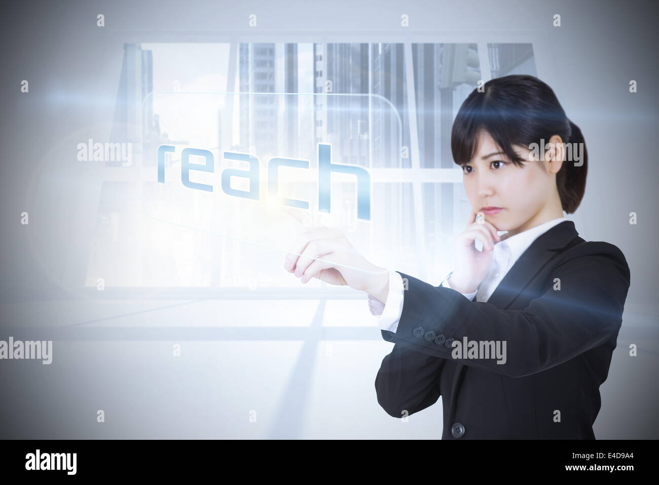 Businesswoman pointing to word reach Stock Photo - Alamy