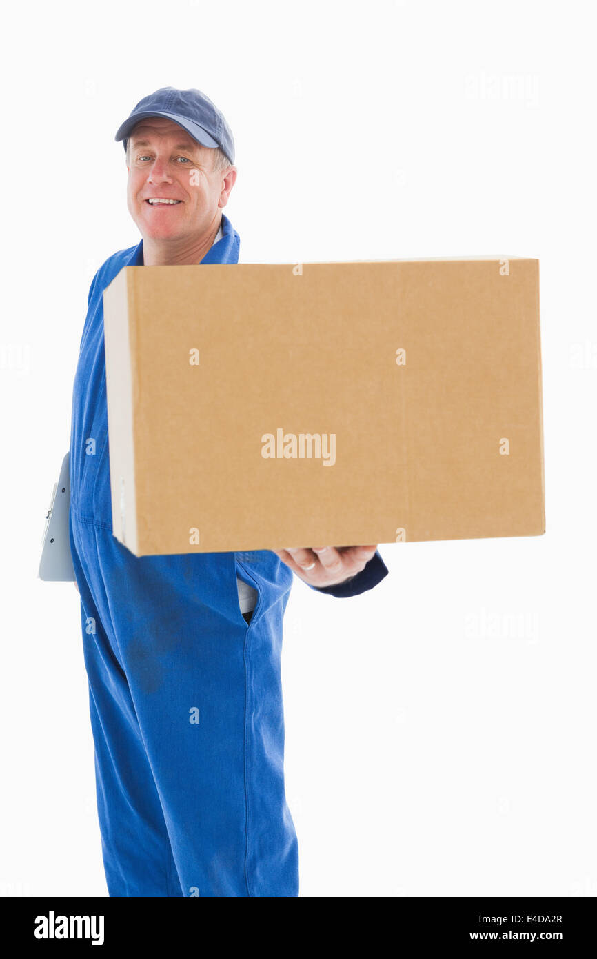 Happy delivery man showing cardboard box Stock Photo - Alamy