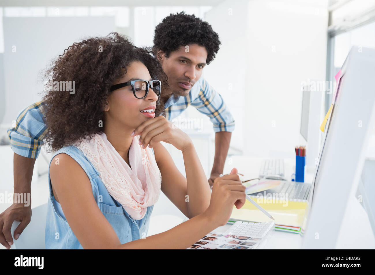 Young design team working together at desk Stock Photo - Alamy