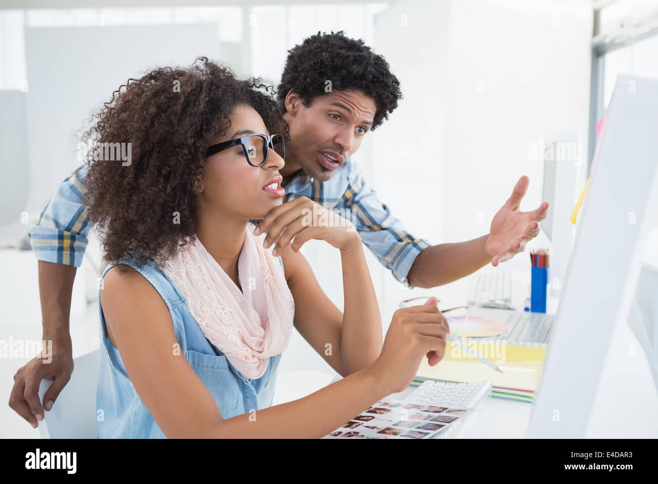 Young design team working together at desk Stock Photo - Alamy