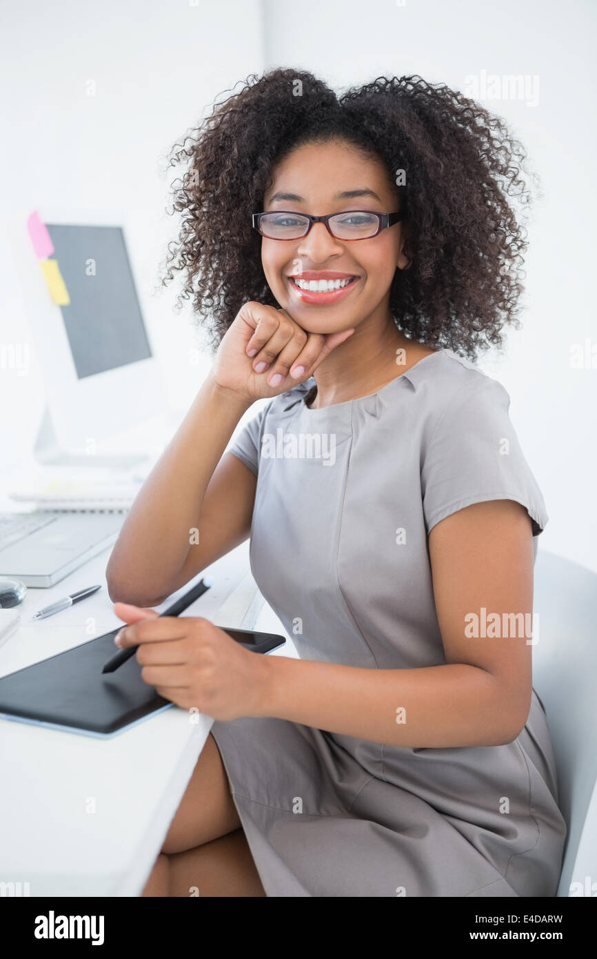 Young pretty designer smiling at camera at her desk Stock Photo - Alamy