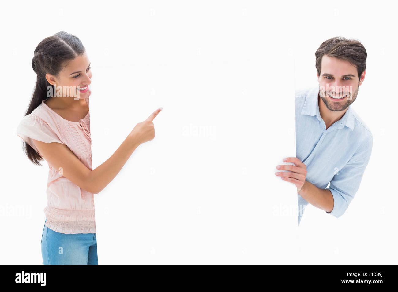 Attractive young couple smiling and holding poster Stock Photo - Alamy