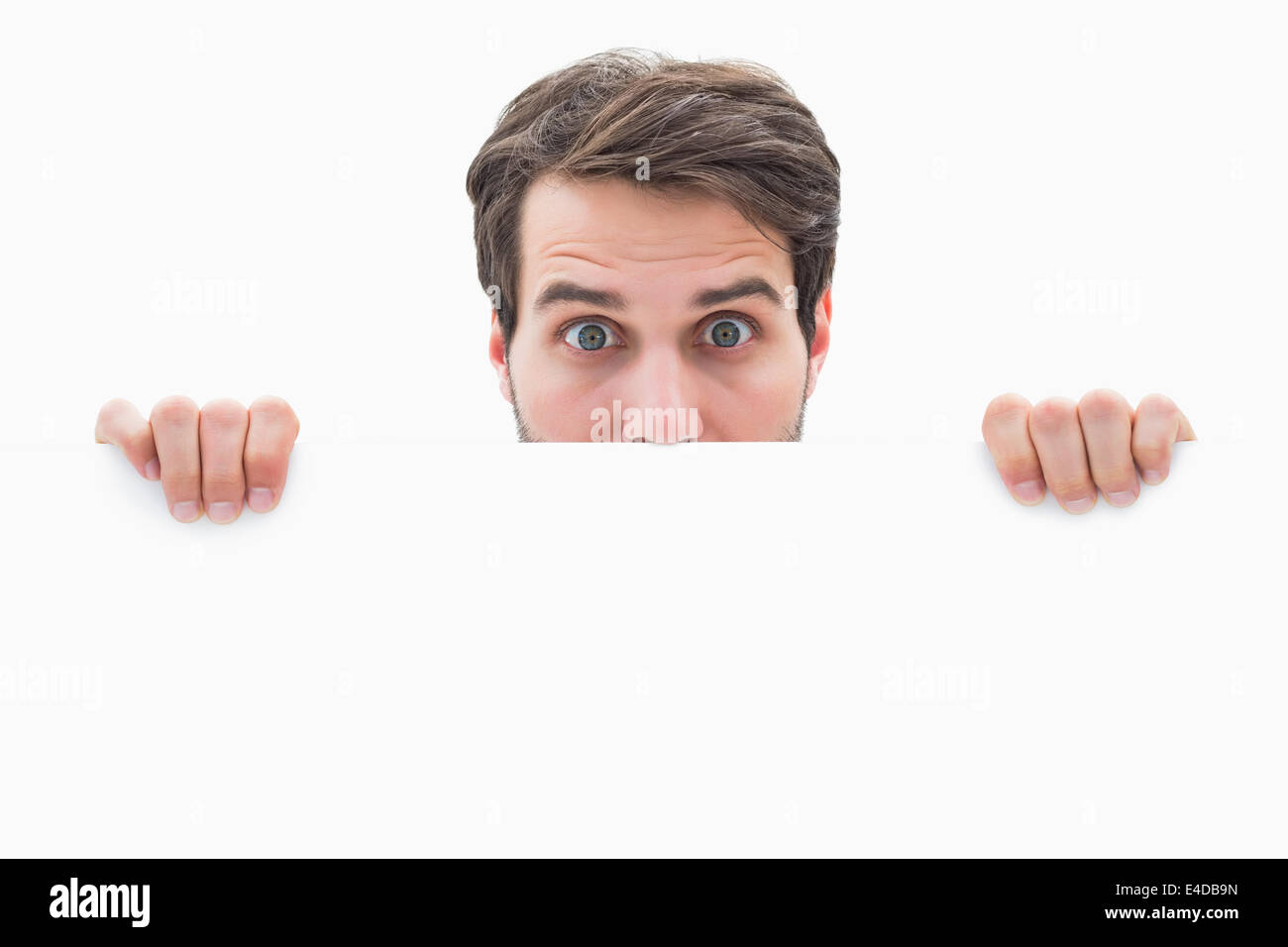 Attractive young man smiling and holding poster Stock Photo - Alamy